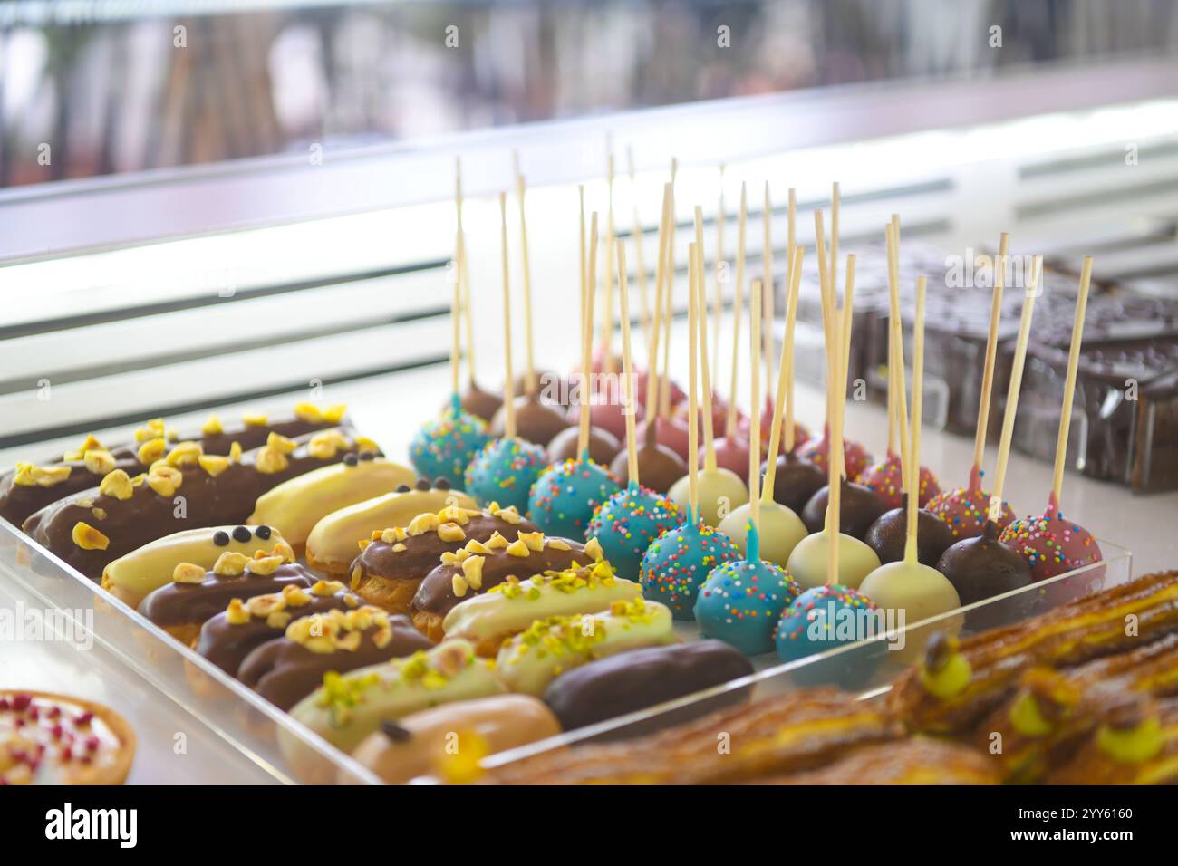 Pastry shop glass display with selection of sweets and cakes ...