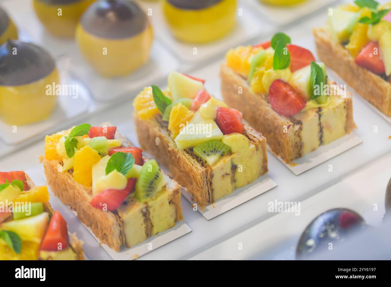 Pastry shop glass display with selection of sweets and cakes ...