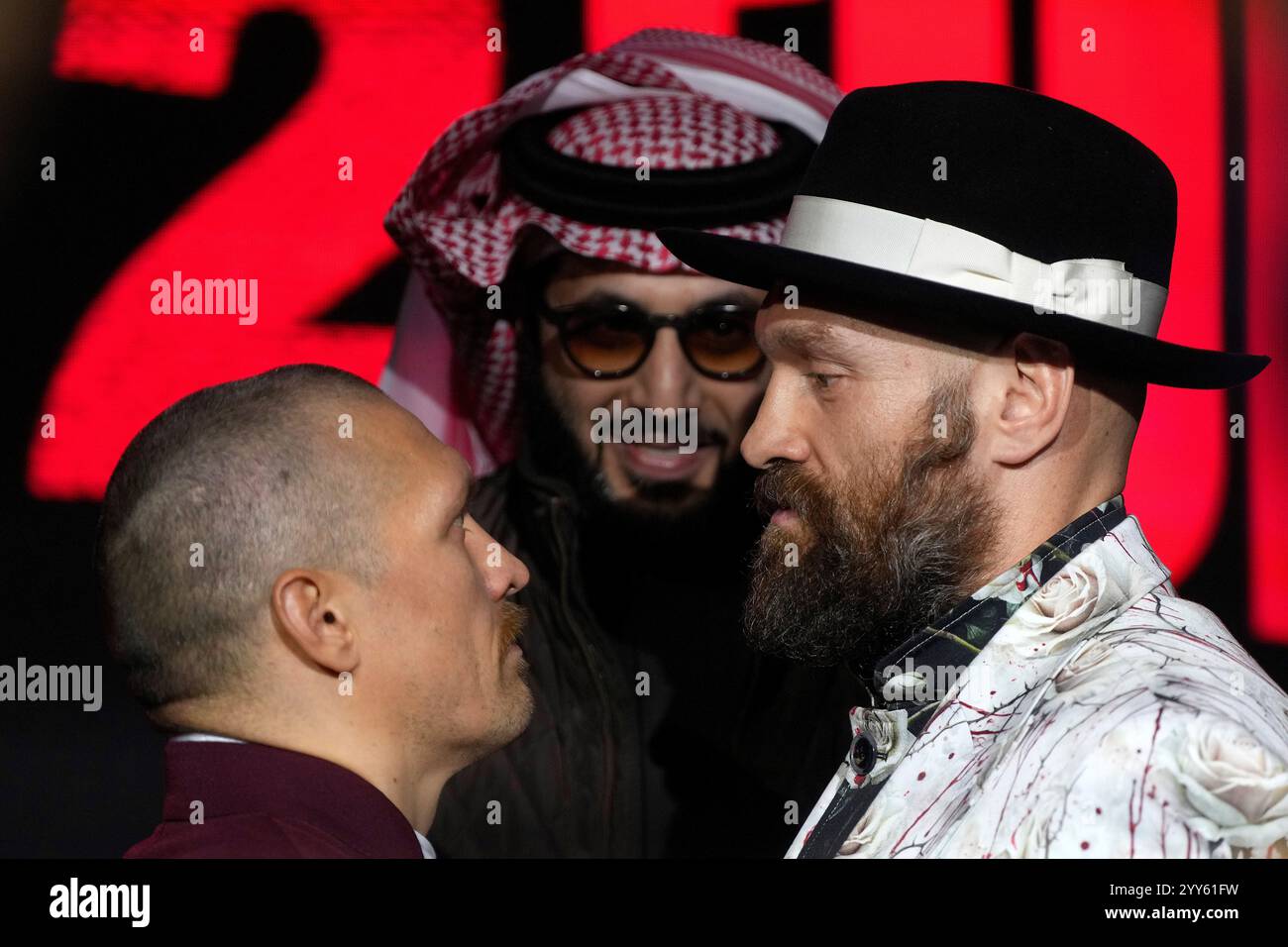 Boxer Tyson Fury, right, and Oleksandr Usyk, left, face off under the ...