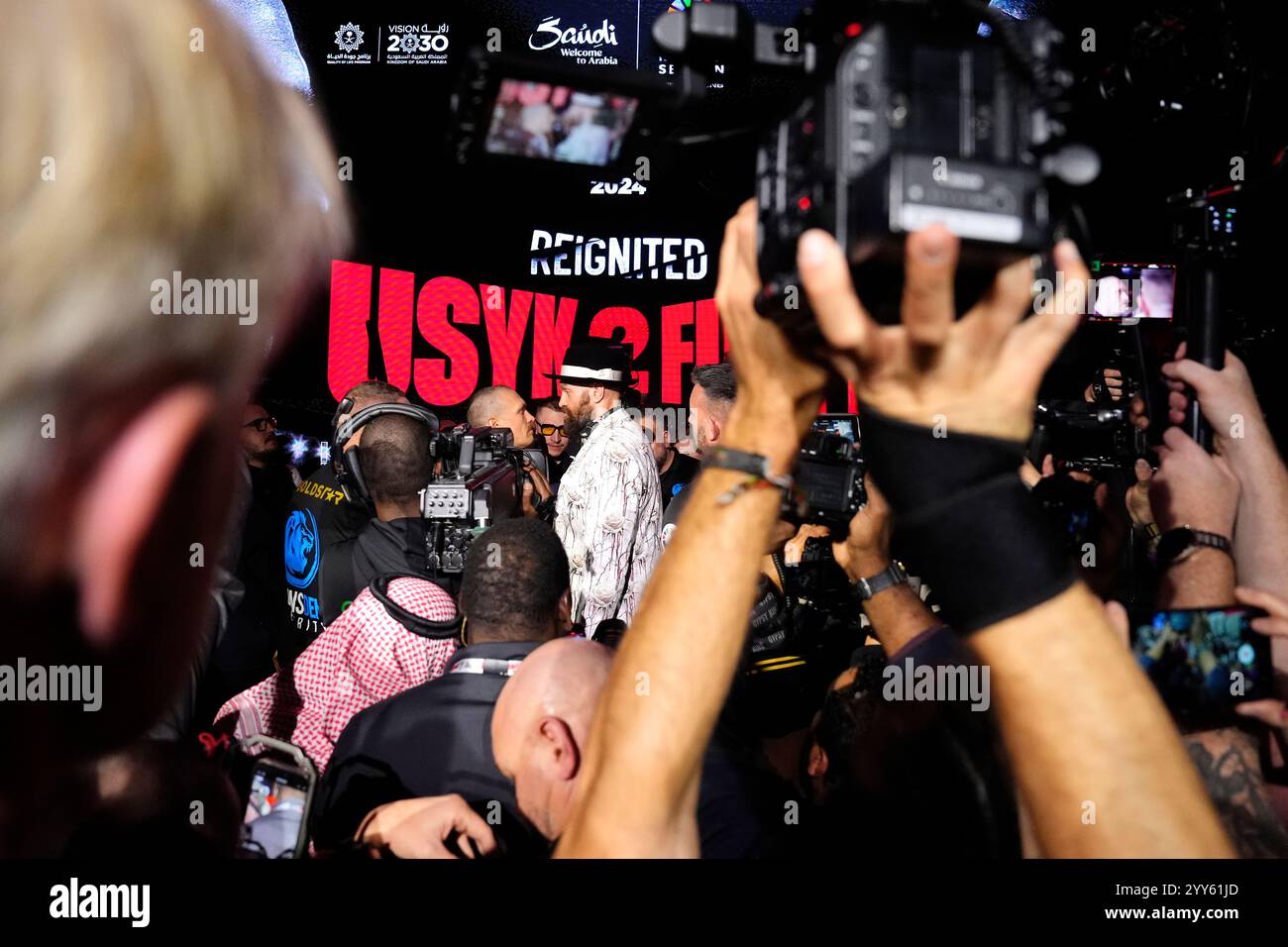 Oleksandr Usyk (left) and Tyson Fury face off during a press conference ...