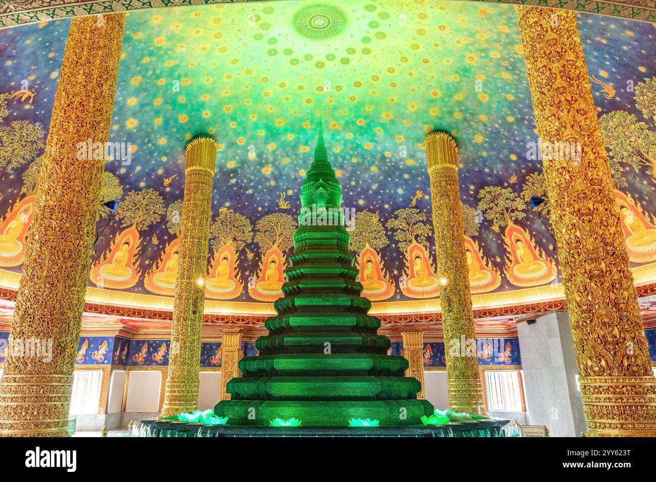 Emerald green glass pagoda surrounded by intricately decorated golden ...