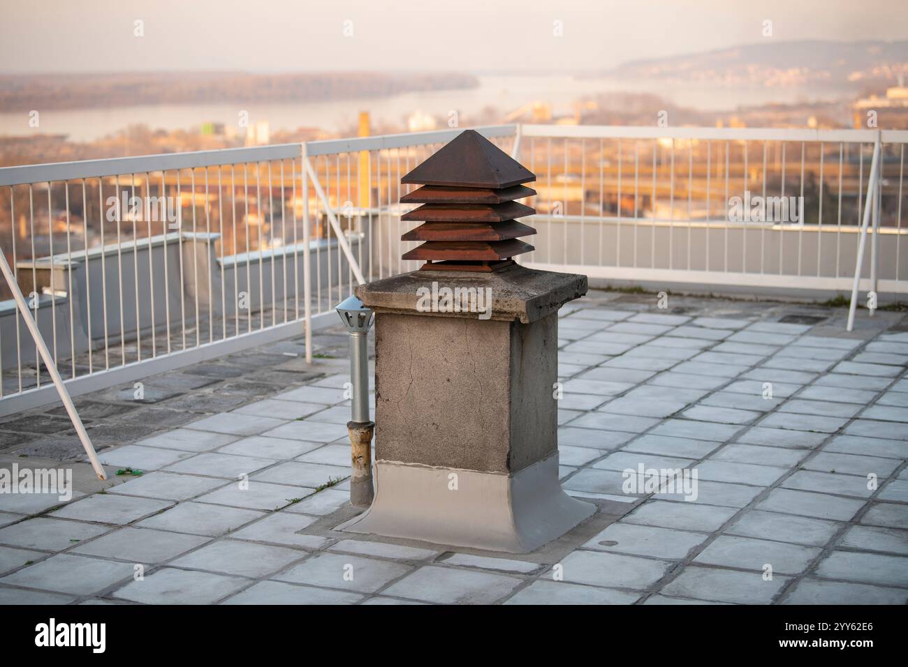 Chimney system on flat rooftop of residential building, with cityscape ...