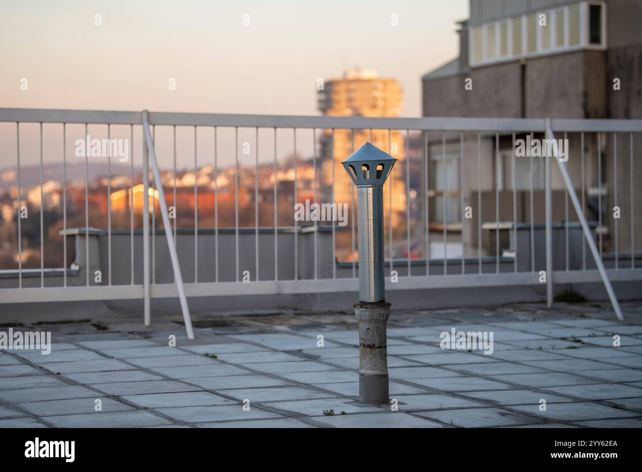 Chimney system on flat rooftop of residential building, with cityscape ...