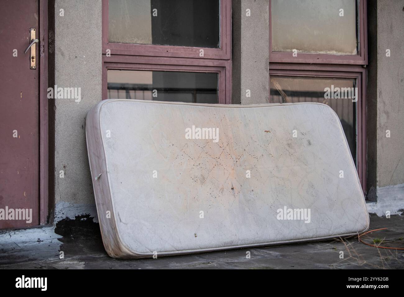 Old, forgotten, dirty mattress dumped on rooftop of residential ...