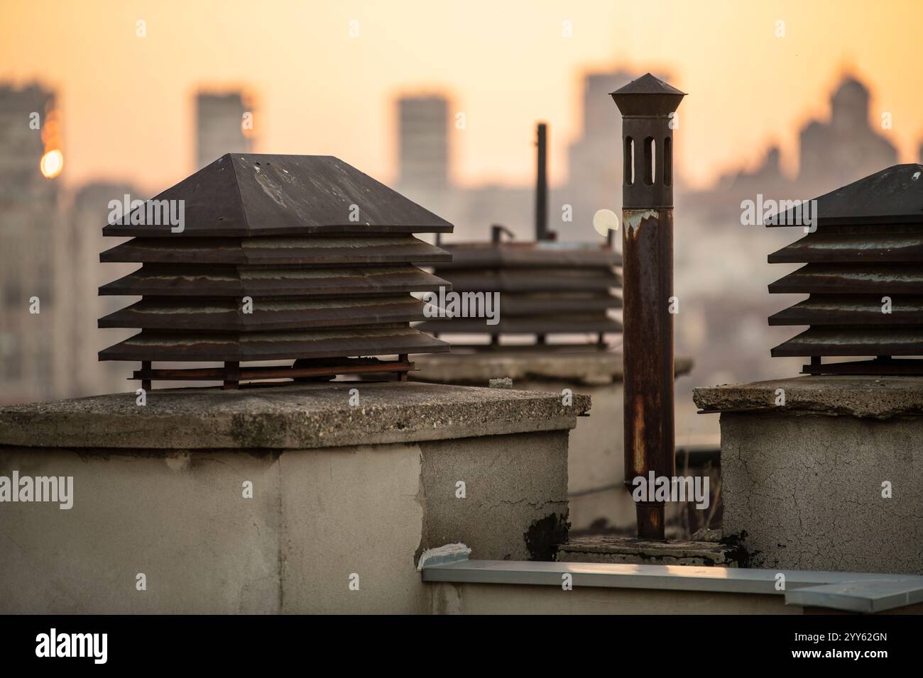 Chimney system on flat rooftop of residential building, with cityscape ...