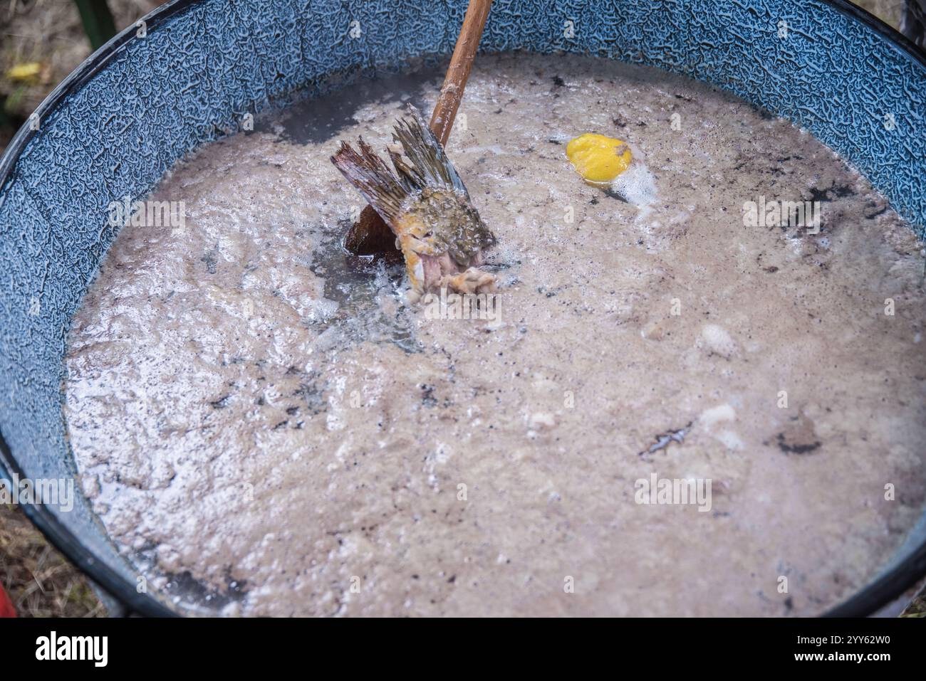 Mixing and cooking fish soup in big caldron made on fire Stock Photo ...