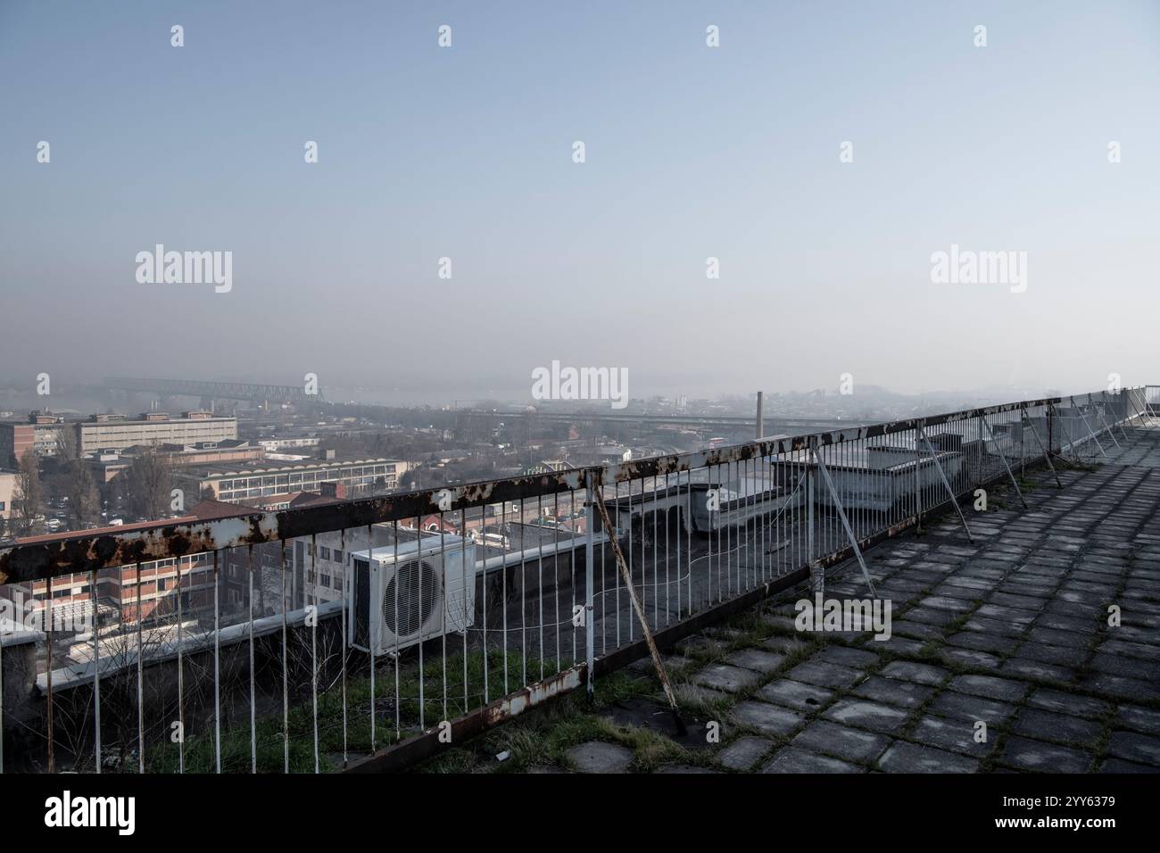 Safety fence on skyscraper rooftop with city background at sunset ...