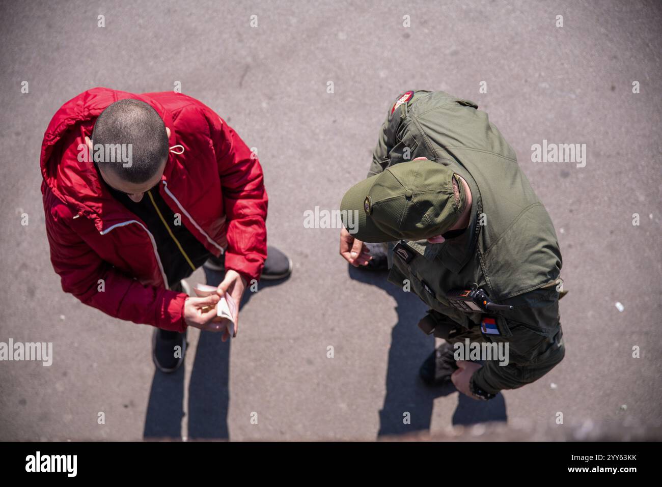 A special military police force officer checking citizen for valid ...