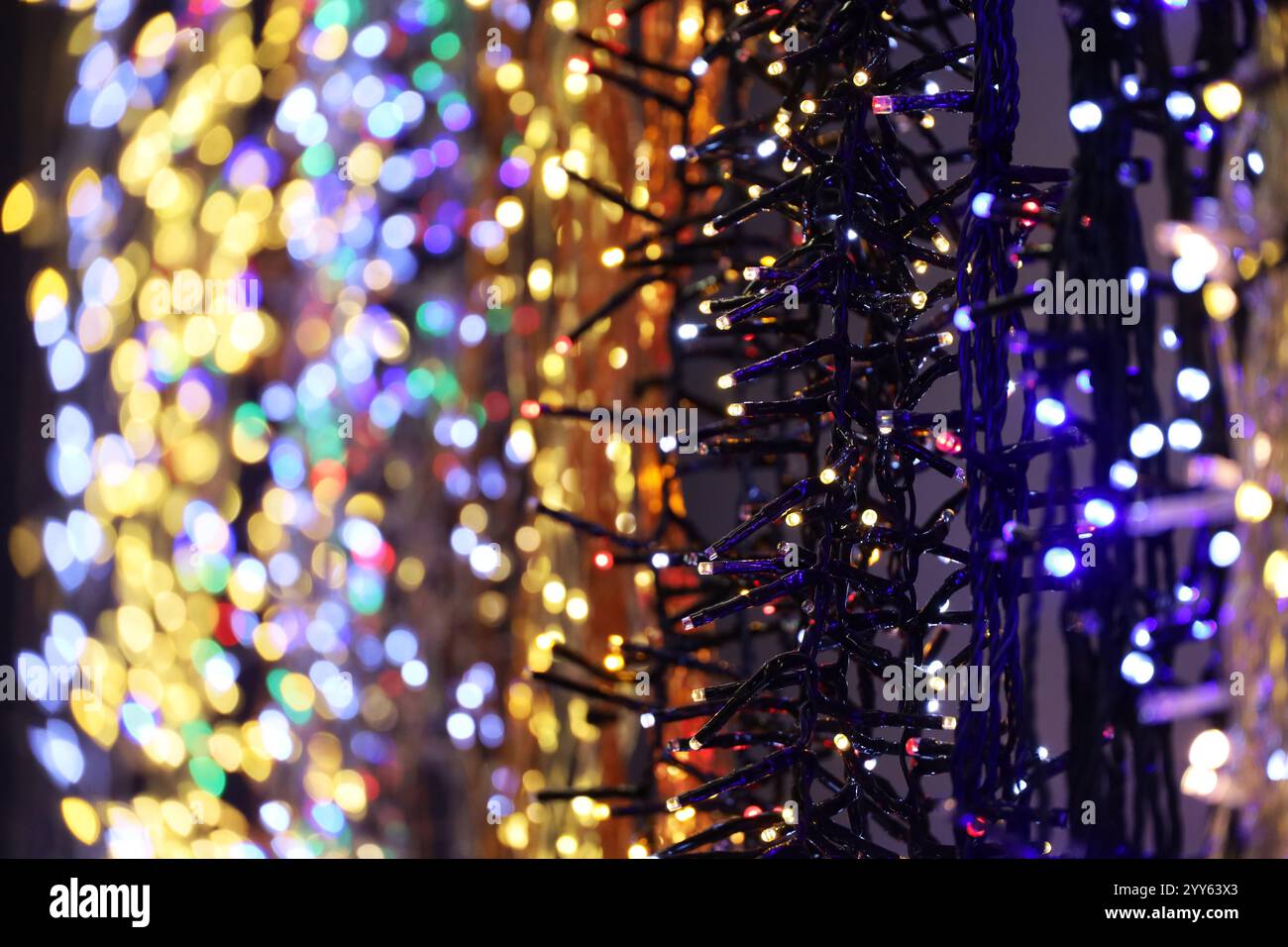 Christmas lights on electric garlands in a shop. New Year decorations ...