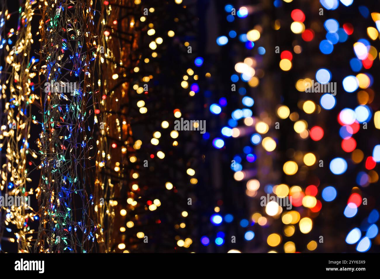 Christmas lights on electric garlands in a shop. New Year decorations ...