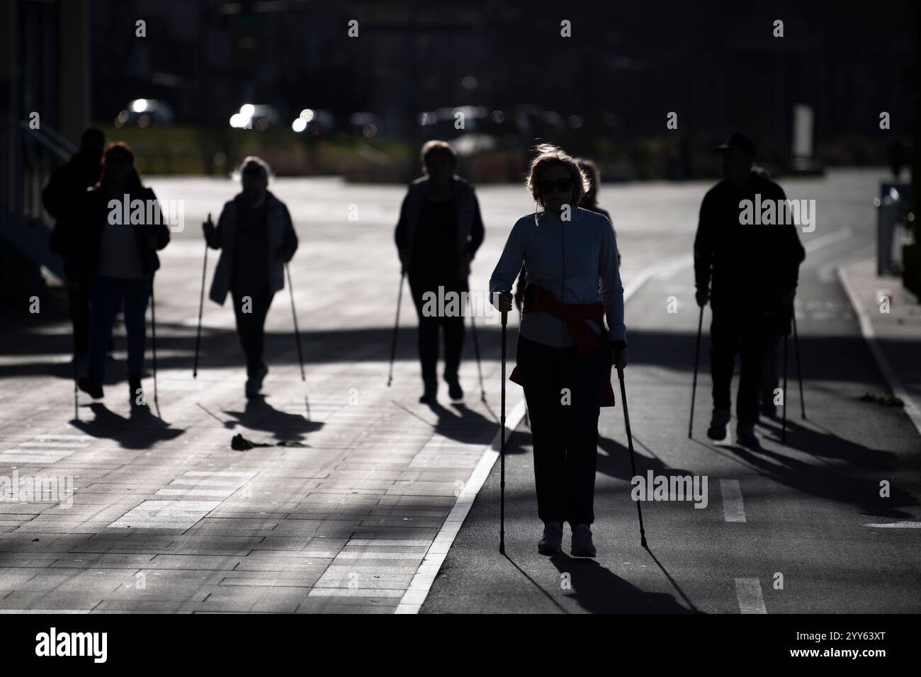 Large group of Senior people making nordic walking by river on ...