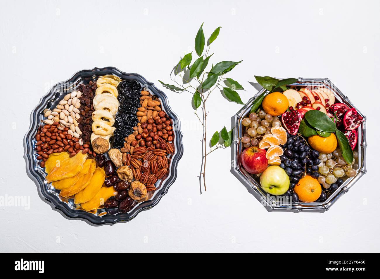 Two silver dishes with traditional dried fruit and nut treats for Tu Bi ...