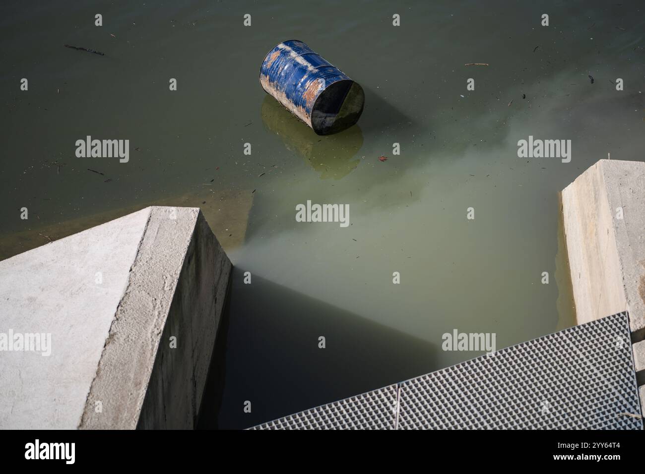 Dirty orange water from sewage pipeline mixes with river water in the ...