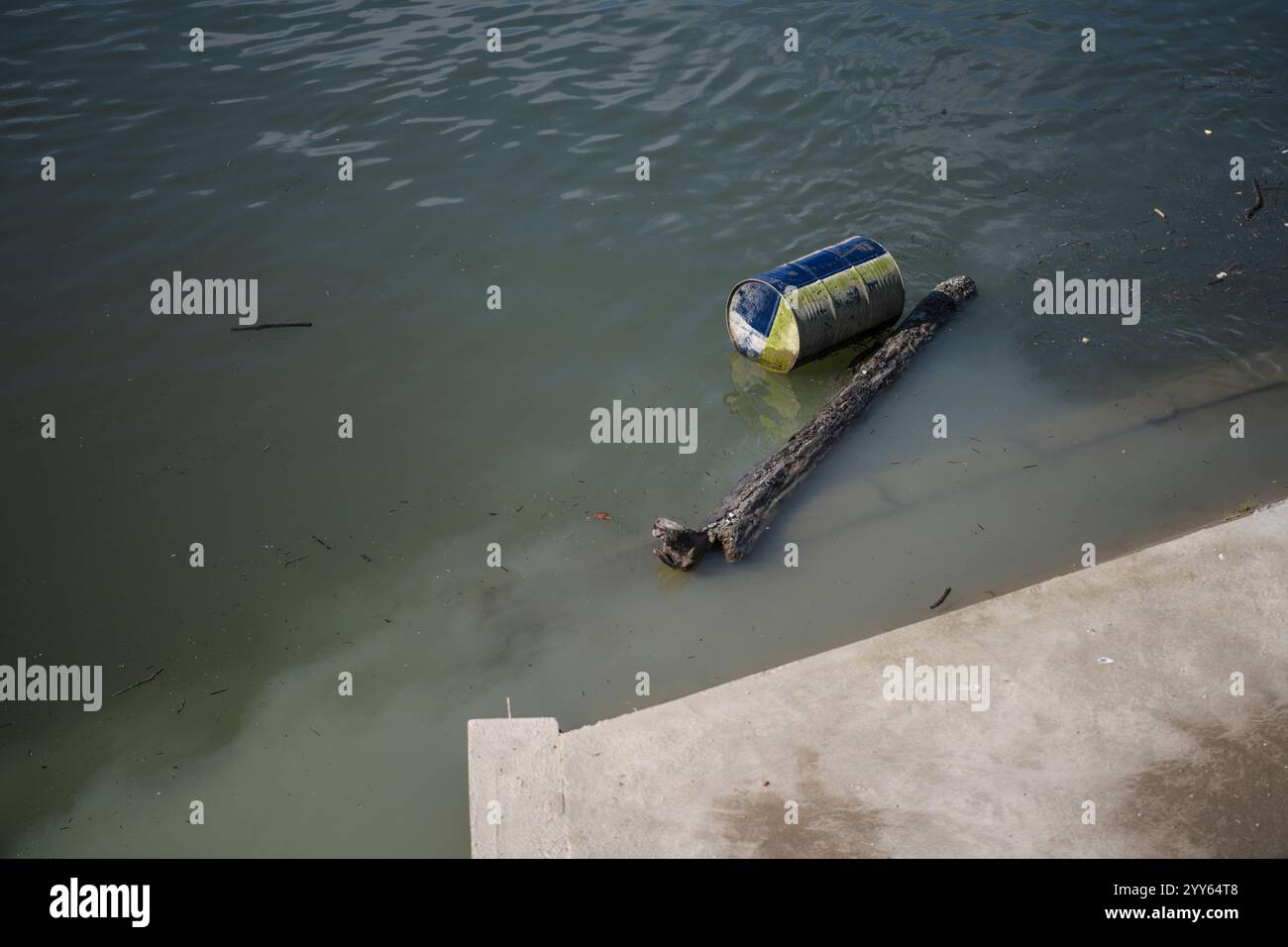 Dirty orange water from sewage pipeline mixes with river water in the ...