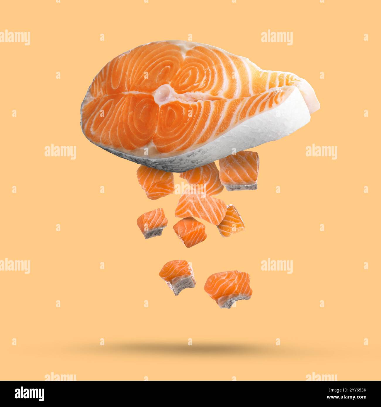 Red fish steak and pieces falling on pale orange background Stock Photo ...