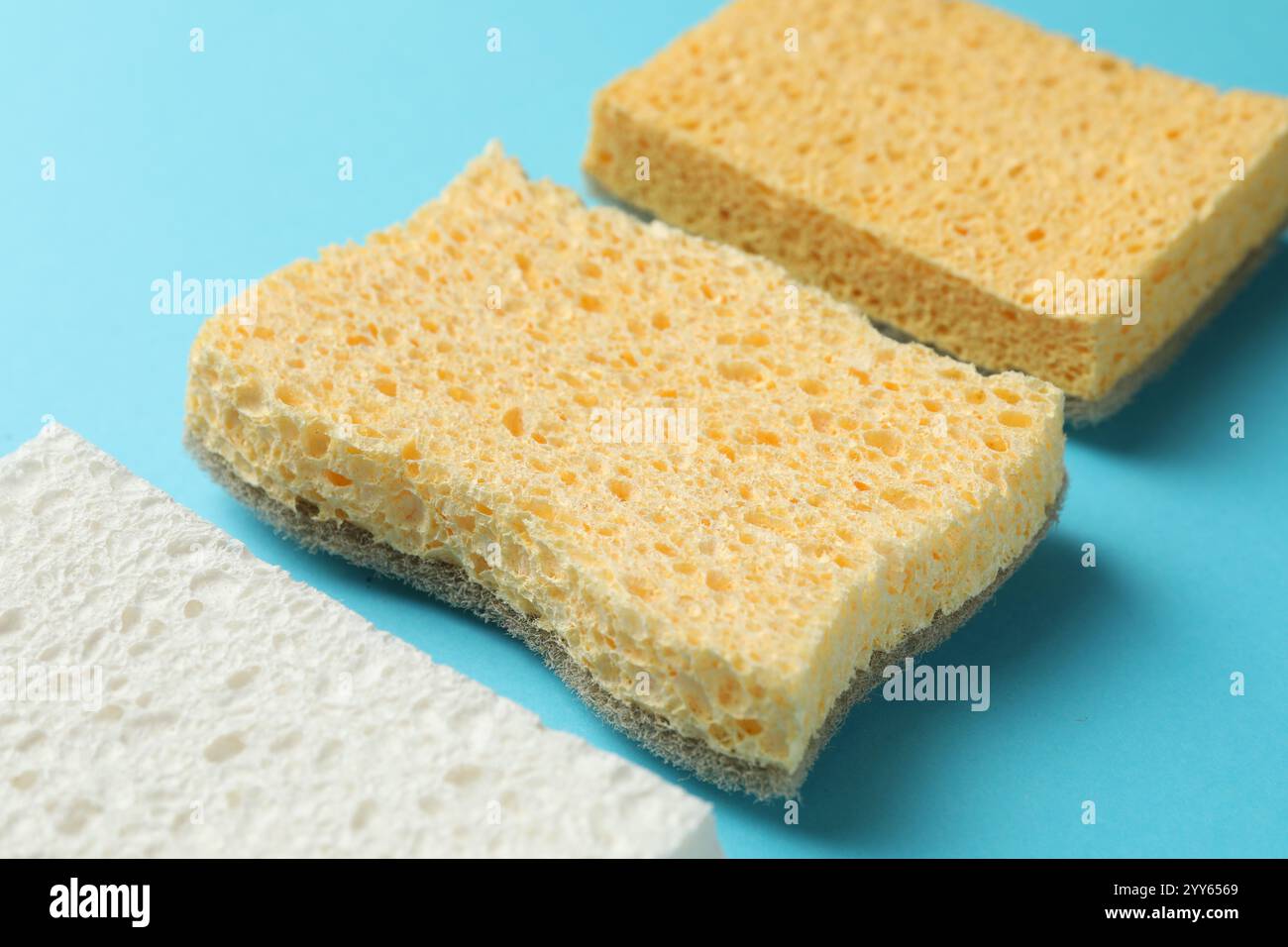 Many sponges on light blue background, closeup Stock Photo - Alamy