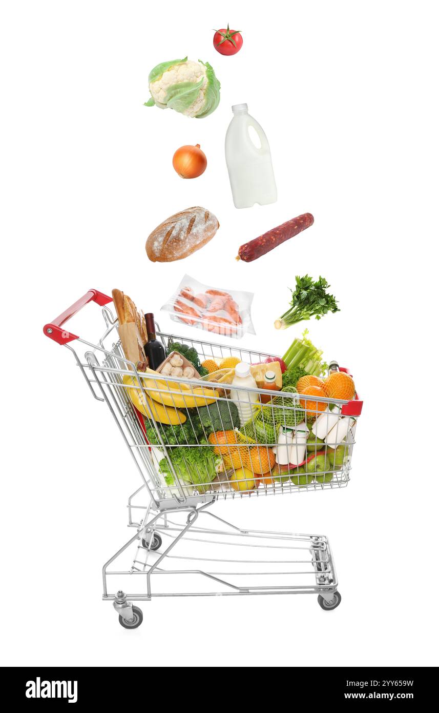 Groceries falling into shopping cart on white background Stock Photo ...