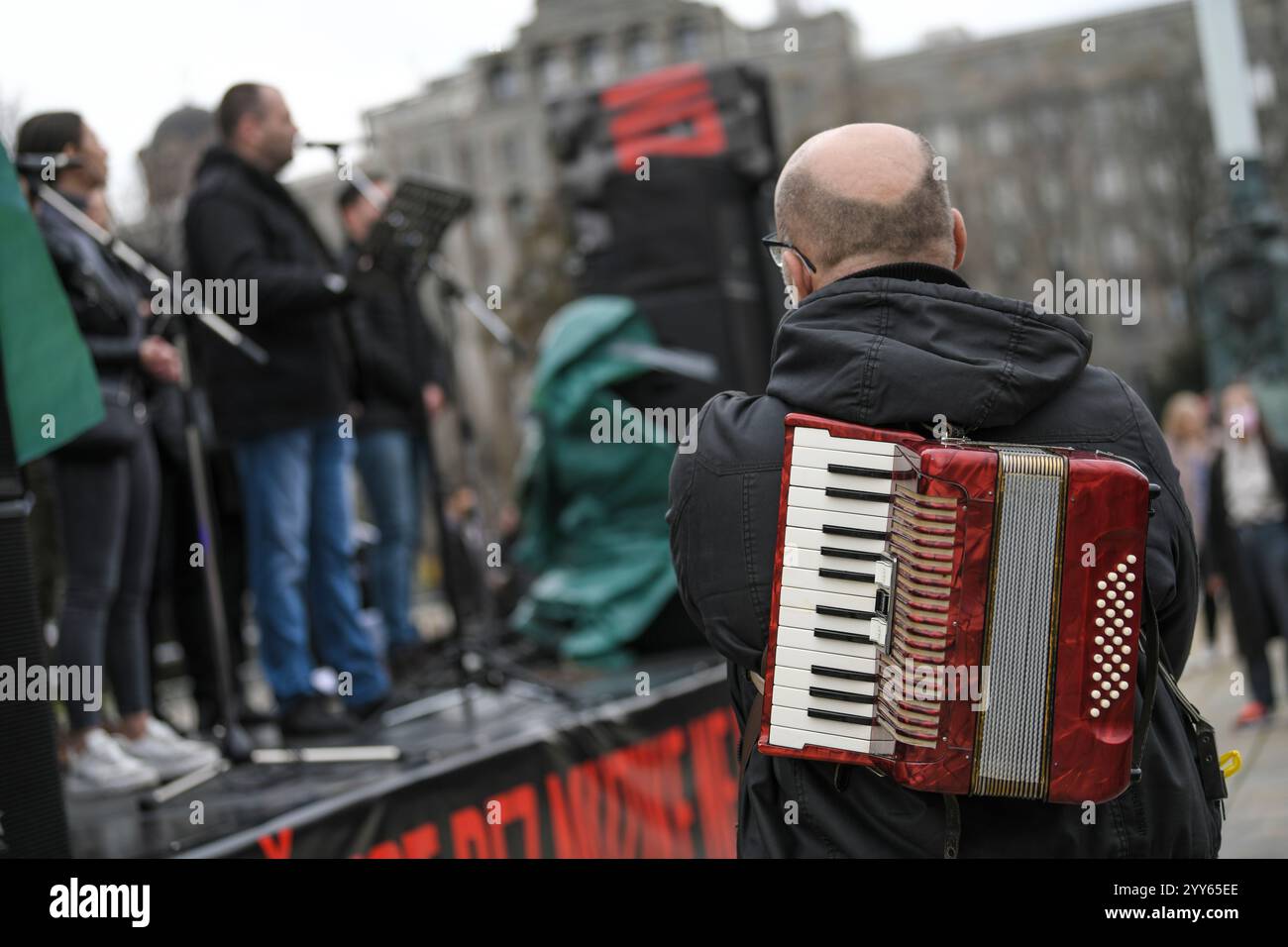 The old rare red accordion hanging on back of an accordion musician ...