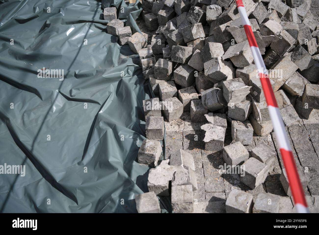 Pellet with many small granite block cobblestone paving stones, stacked, ready to be used on a ...
