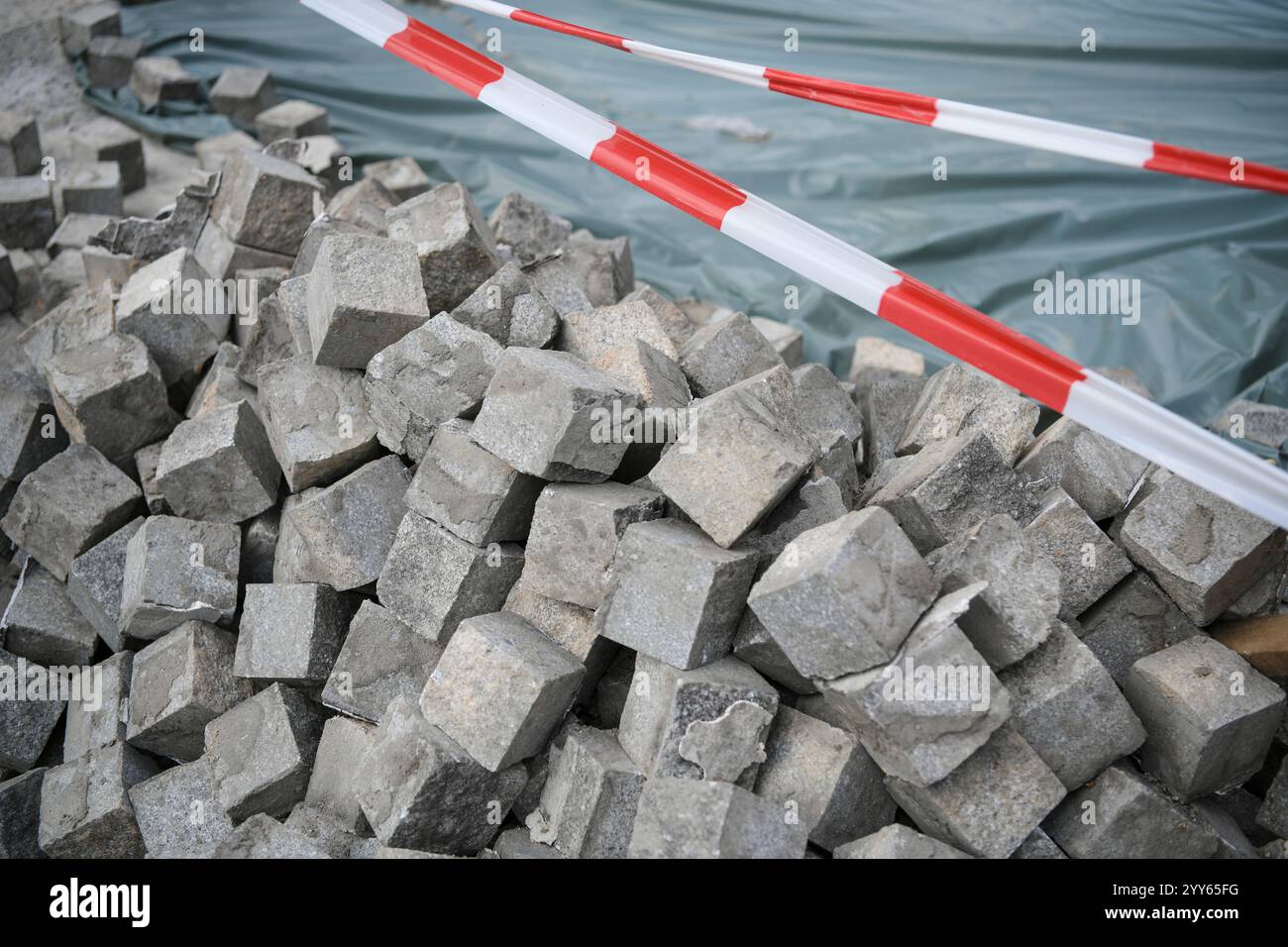 Pellet with many small granite block cobblestone paving stones, stacked, ready to be used on a ...