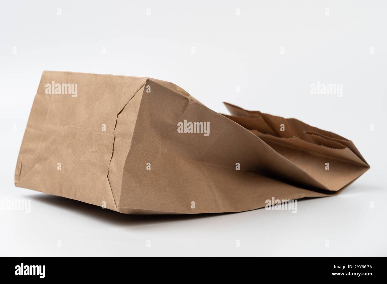 Closed paper bag laying on white studio background Stock Photo - Alamy