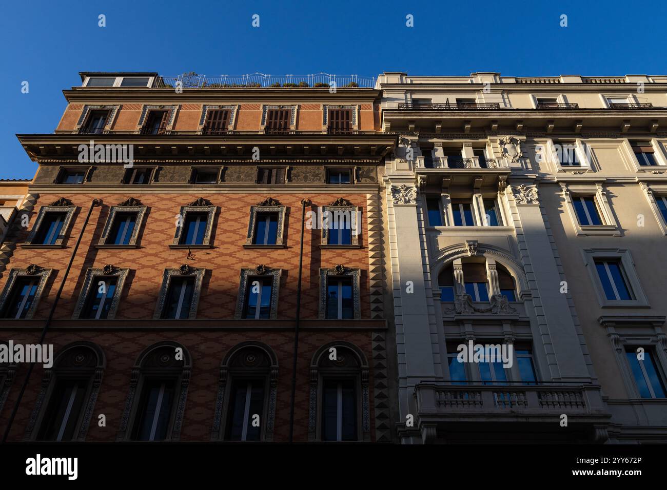 Light and shadow reveal the intricate facades of historic buildings on ...