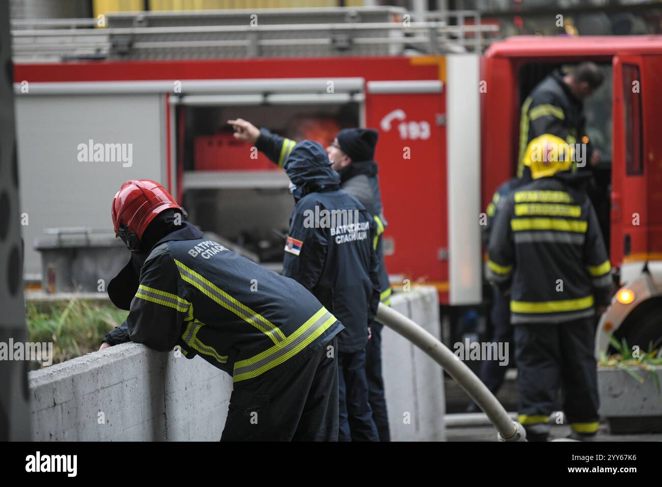 A photo of a firefighters from behind as they rest after putting out a ...