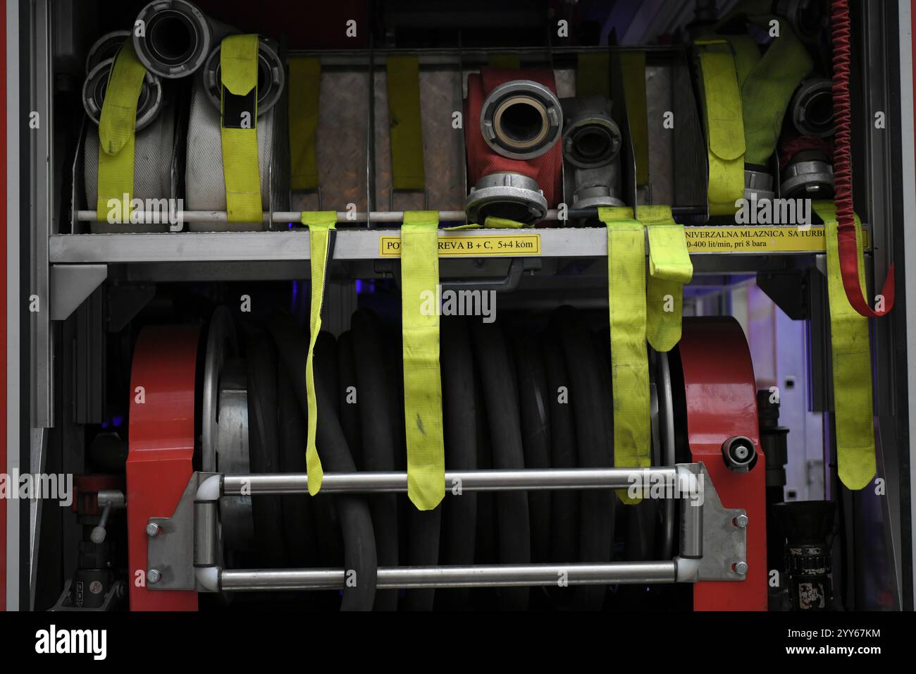 Equipment inside rescue fire truck, fire engine, side view. Rolled up ...