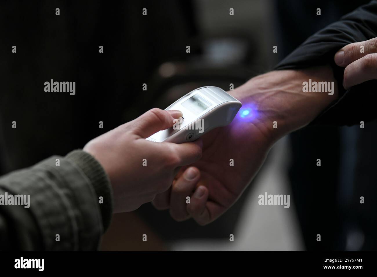 Visitors must go through fever measures using infrared digital ...