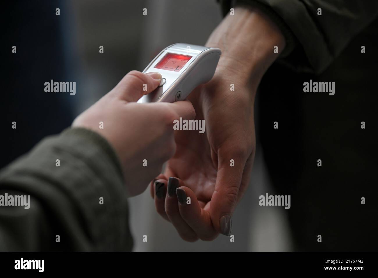 Visitors must go through fever measures using infrared digital ...