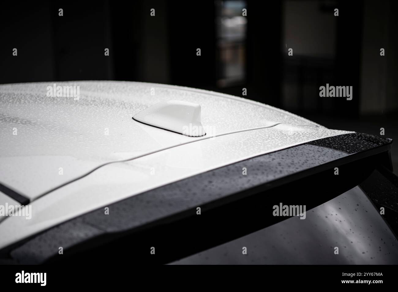 Close-up white GPS antenna shark fin shape on a roof of car for radio ...