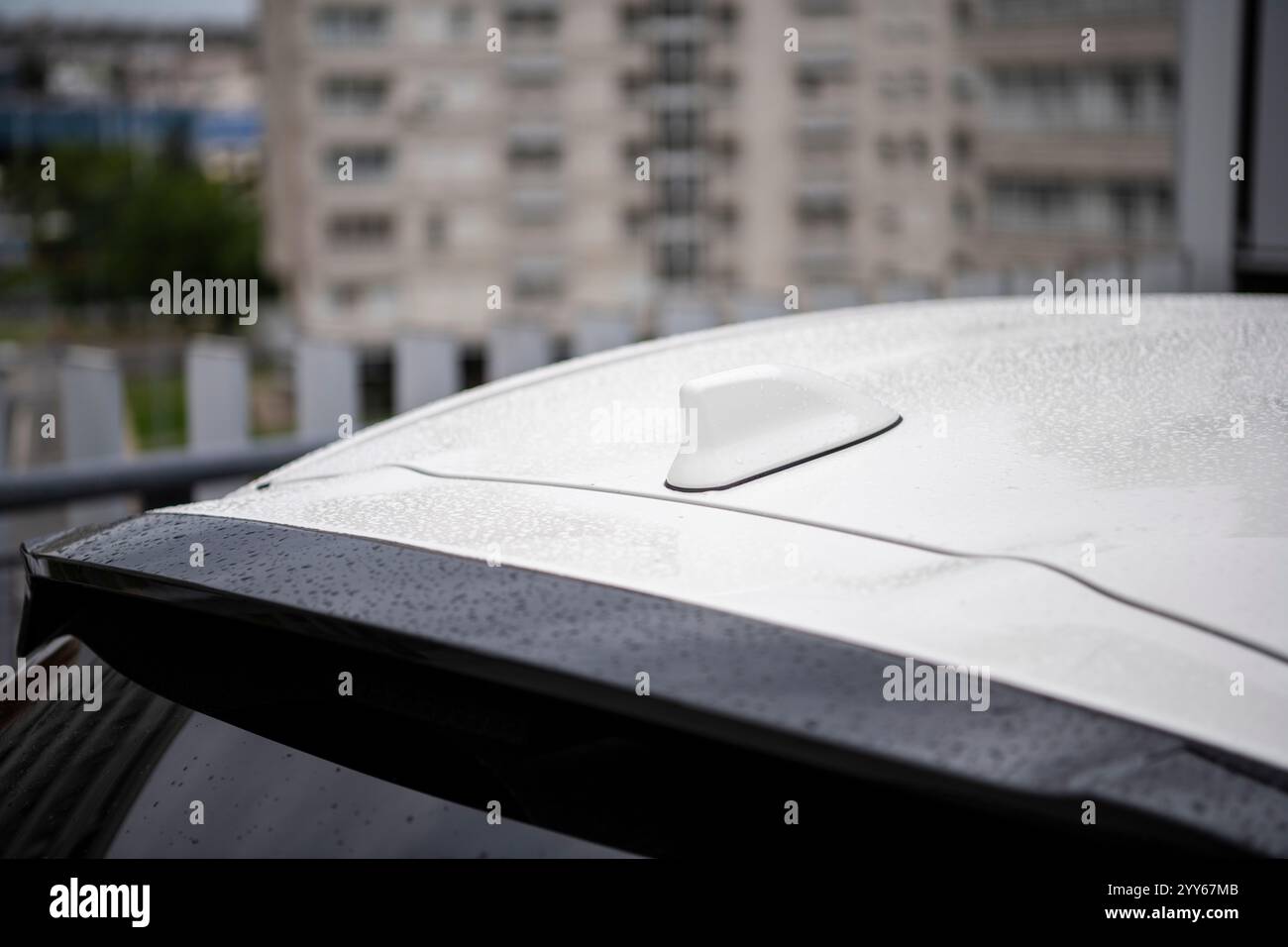 Close-up white GPS antenna shark fin shape on a roof of car for radio ...