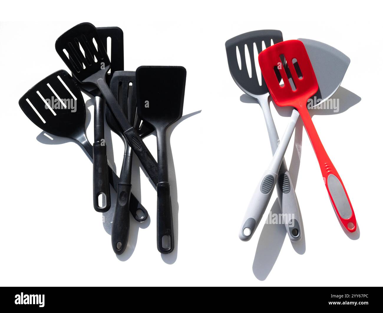 A collection of black plastic Kitchen utensils on white background ...