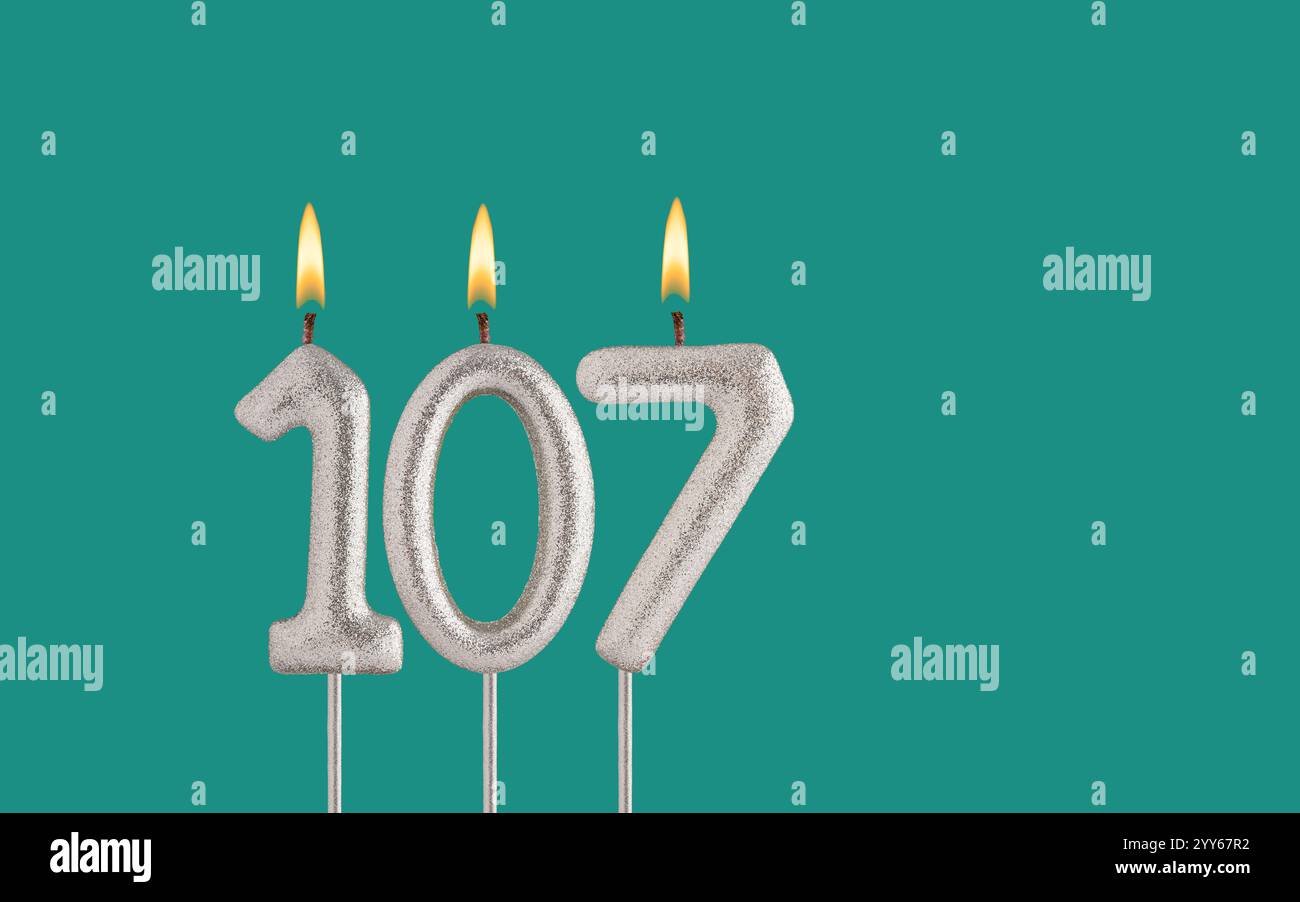 Birthday candle number 107 - Card on a green background Stock Photo - Alamy