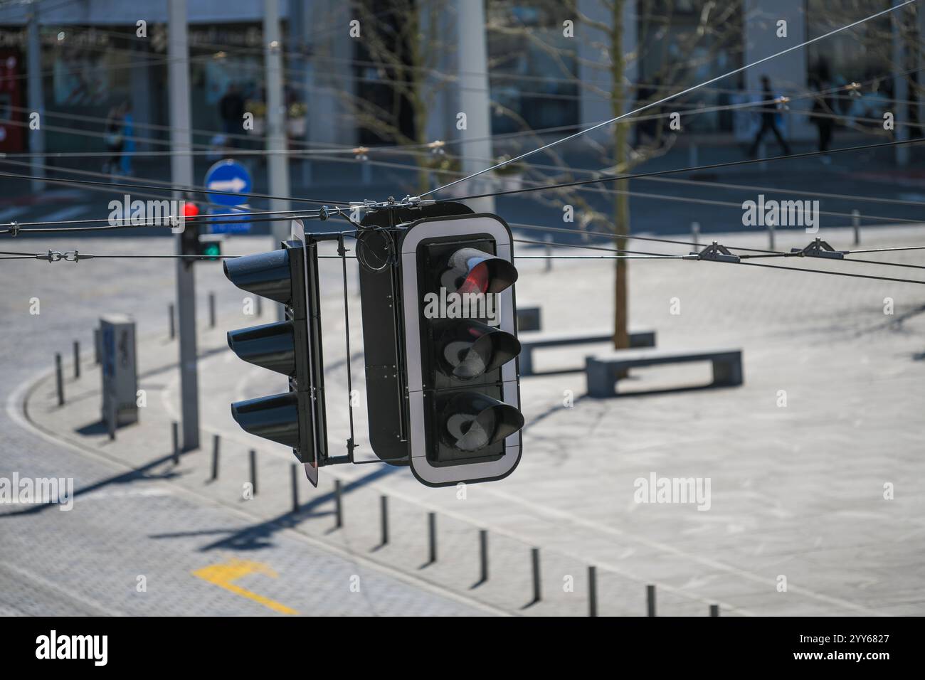A view at a traffic light hanging on wires above the road traffic, over ...