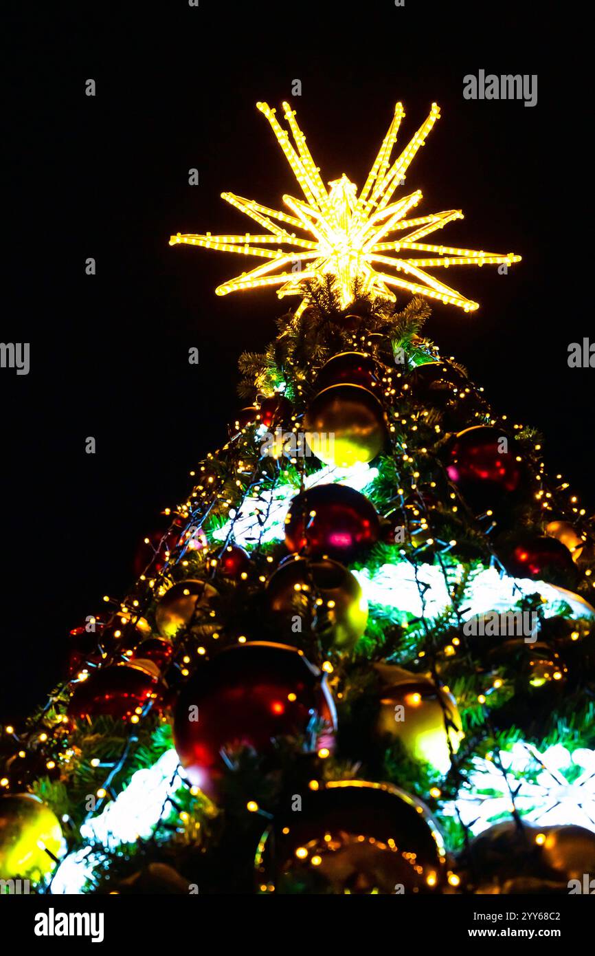 New Year tree decorated with a star and garlands, vertical photo Stock ...