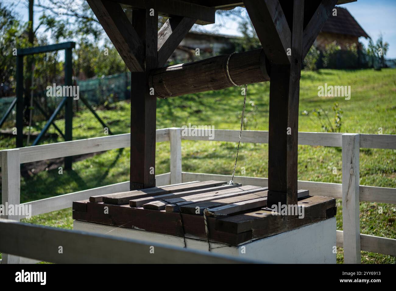 Old wooden draw water well in the countryside, in Serbian Village with ...