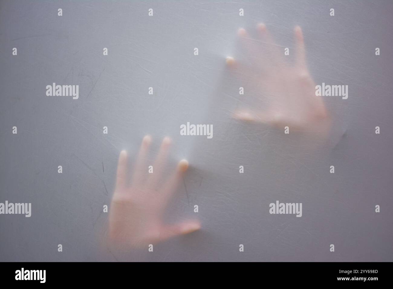 Head and handprint of woman as she suffocates behind fabric, raised ...