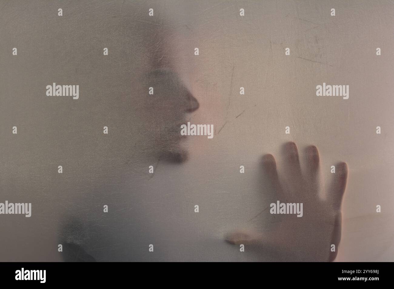 Head and handprint of woman as she suffocates behind fabric, raised ...