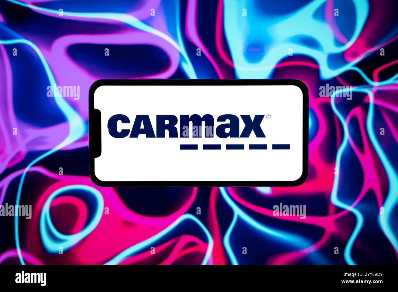 In this photo illustration, the CarMax logo is seen displayed on a ...