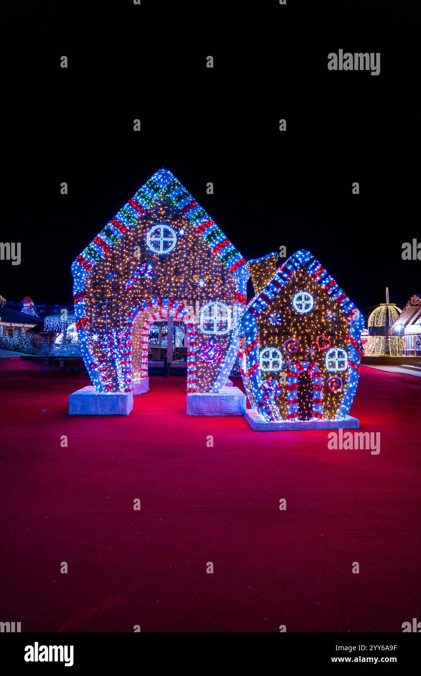 Illuminated gingerbread houses made of colorful LED lights in a ...