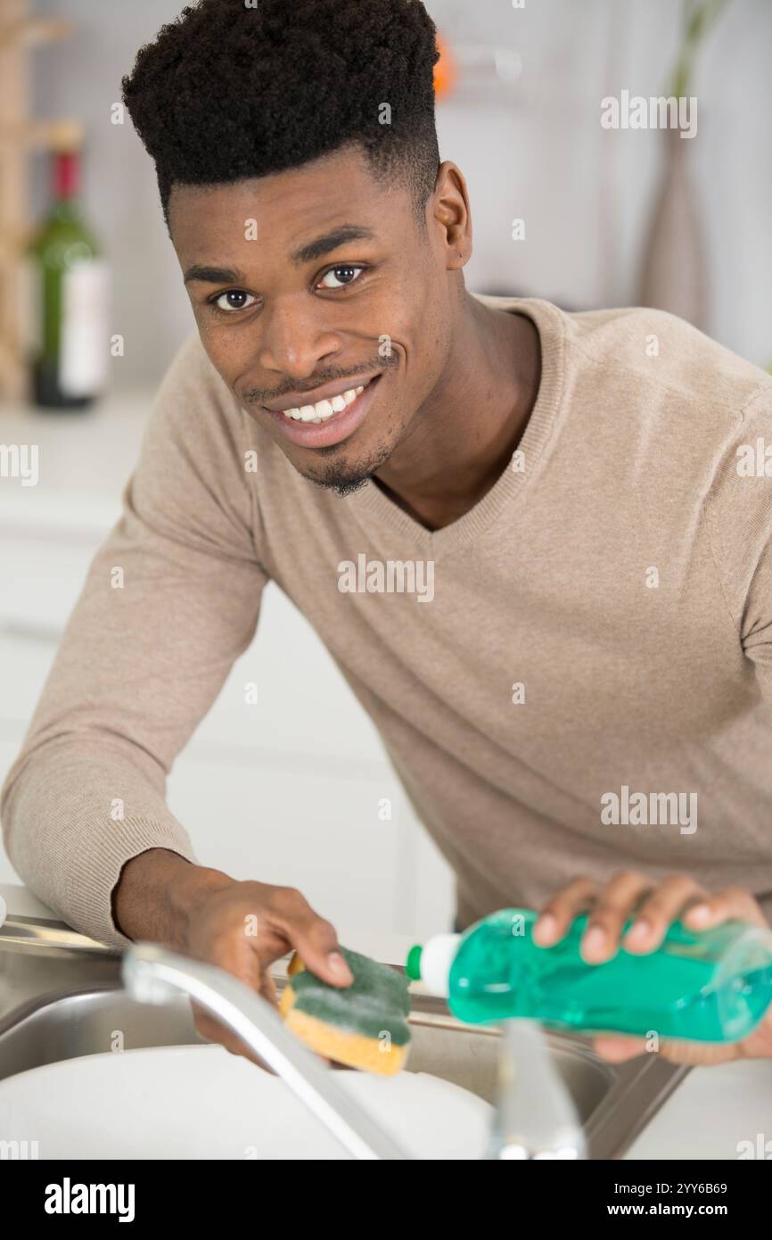 Portrait man washing dishes in hi-res stock photography and images - Alamy