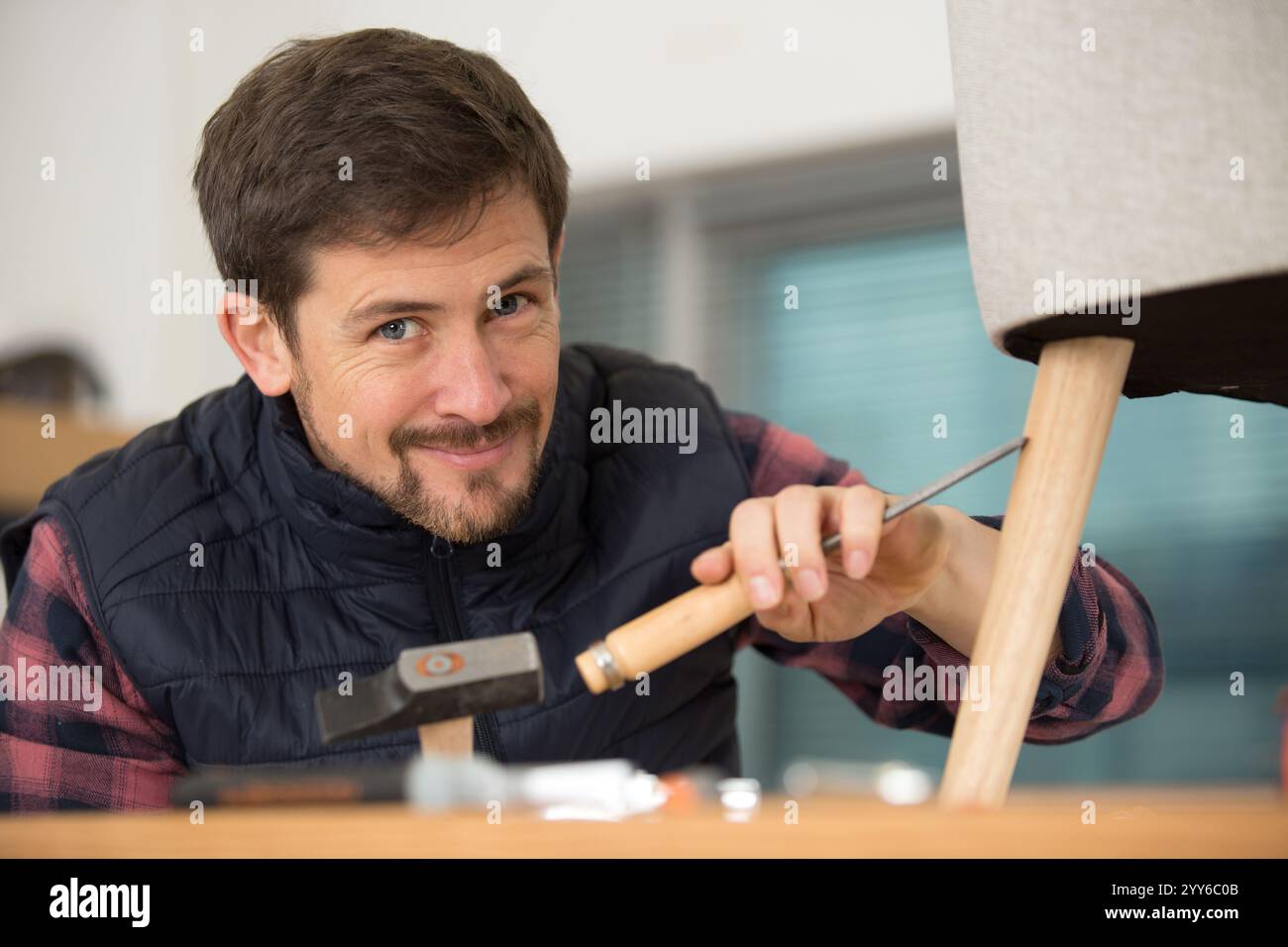craftsman using hammer and chisel to shape a chair leg Stock Photo - Alamy