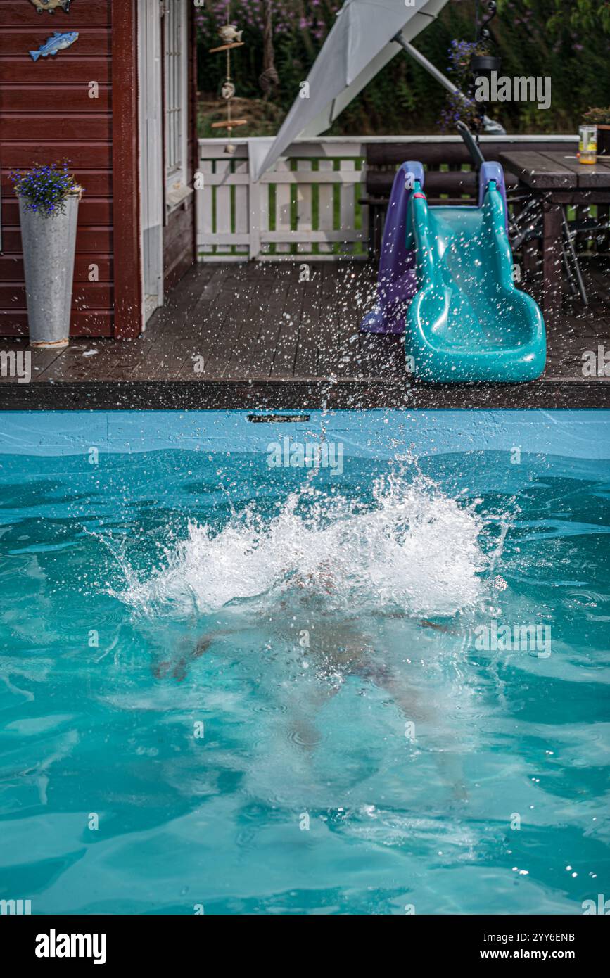 Water splash after a person has jumped in a pool Stock Photo - Alamy