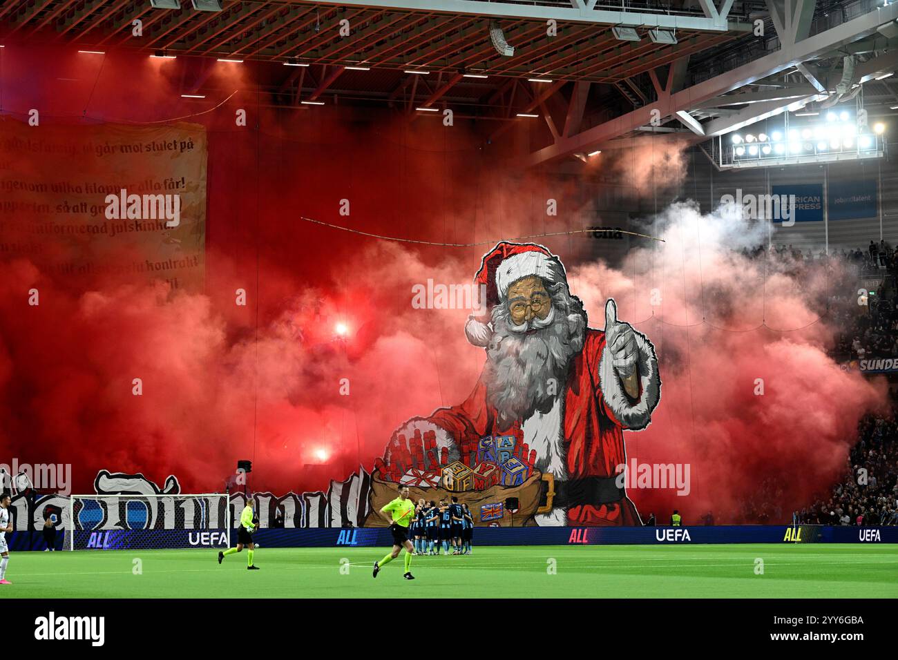 Smoke and Santa Claus tifo are displayed by Djurgården supporters ...