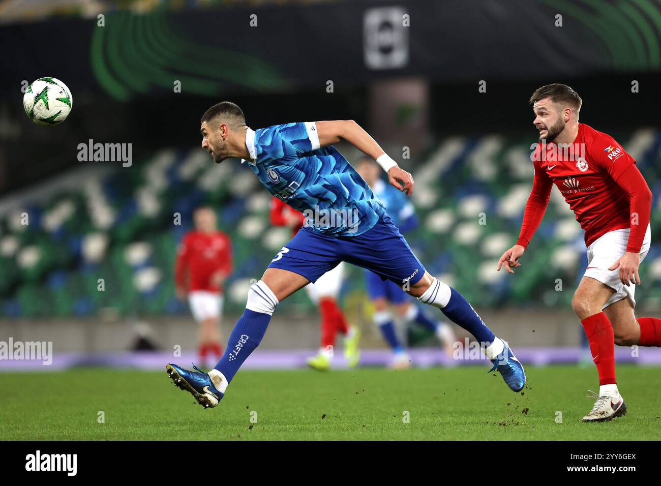 Gent's Stefan Mitrovic (left) and Larne's Andrew Ryan battle for the ...