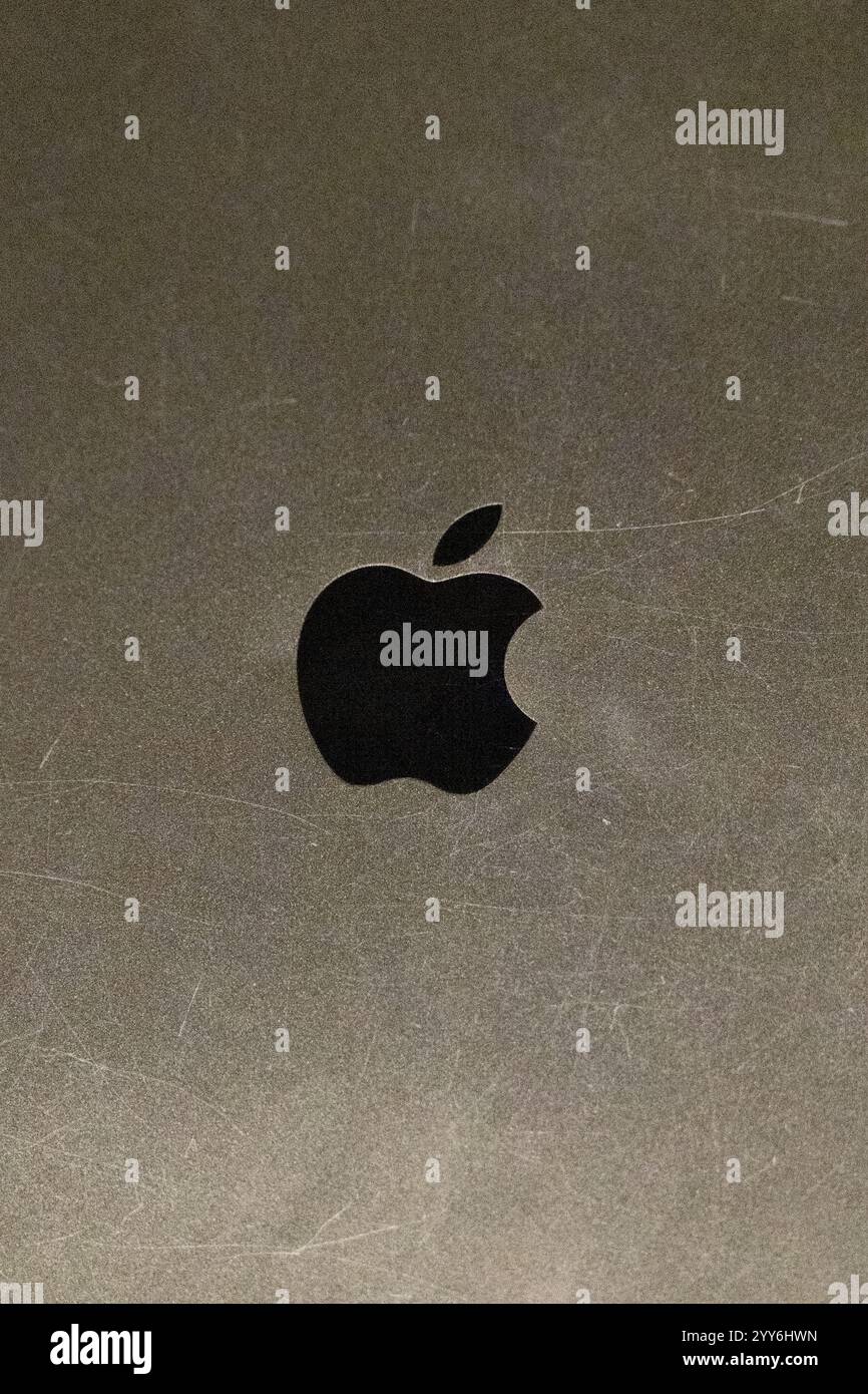 In this photo illustration, An Apple logo is seen on a MacBook Pro ...