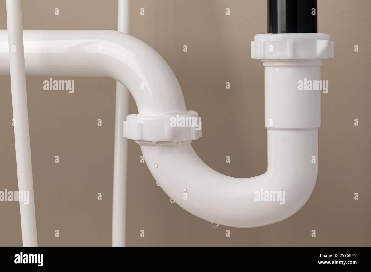 Water dripping from leak on sink drain trap pipes. Plumbing repair and ...