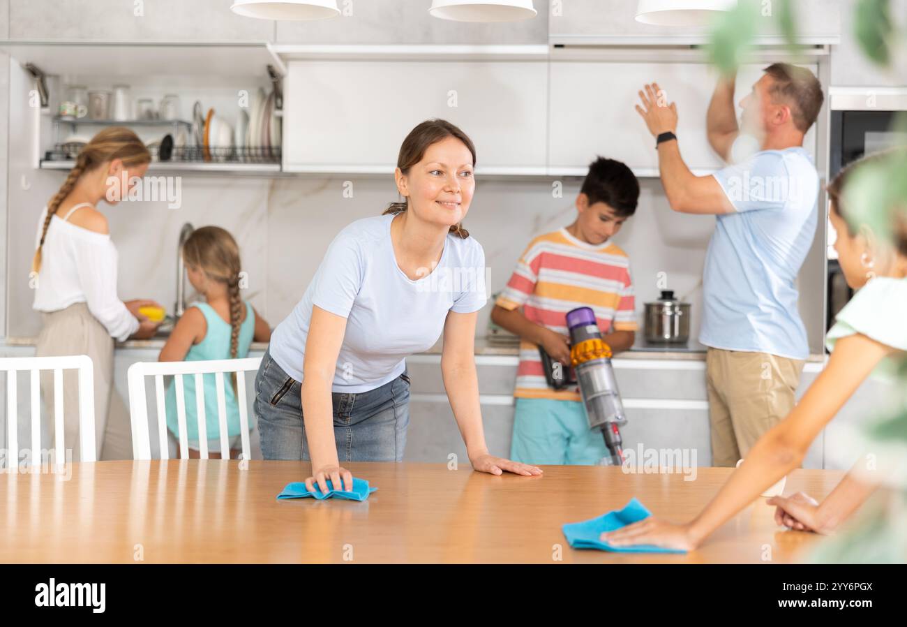 Friendly large family cleans room together. Mom and daughter are ...
