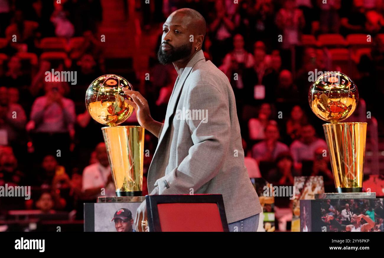 Former Miami Heat player Dwyane Wade touches one of the team's NBA ...